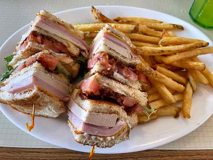 A club sandwich stacked high and cut clean, the kind of lunch that makes you cancel your afternoon plans.