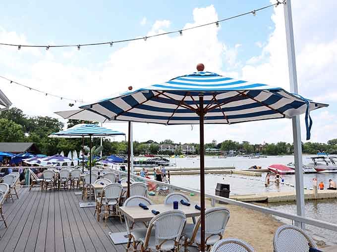 Lindy's Landing delivers waterfront dining with blue-striped umbrellas, string lights, and views of Bangs Lake that make every meal taste better.