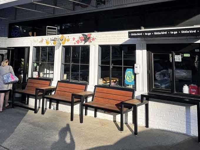 Those wooden benches out front aren't just for waiting, they're where the anticipation officially begins.