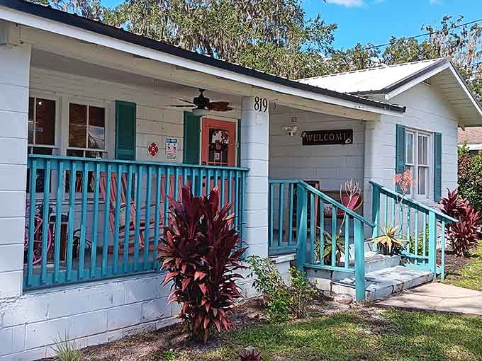 Turquoise railings, a welcome sign, and a front porch that means exactly what it says.
