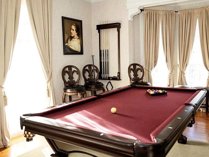 A billiard room with ornate chairs and a portrait watching your every shot. No pressure whatsoever.