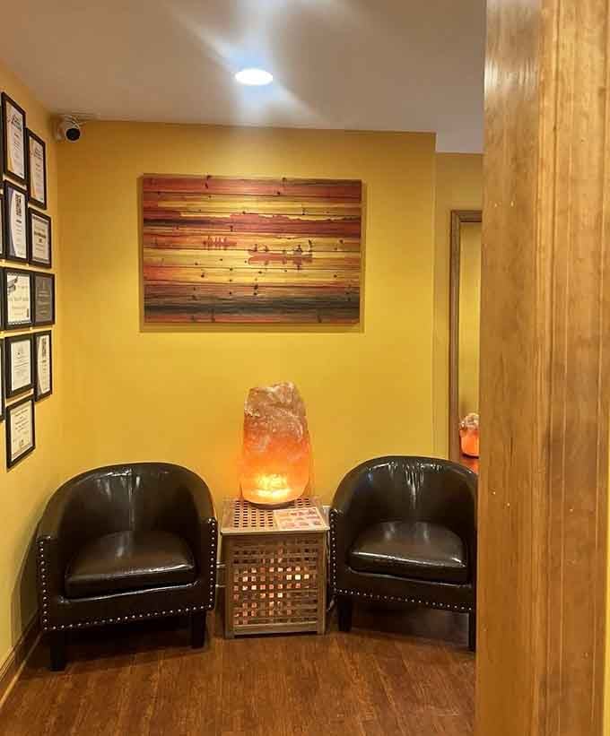 A glowing salt lamp between two leather chairs turns this waiting area into the calmest corner in all of Virginia.