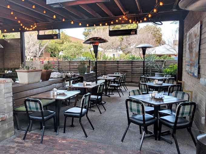 Windsor's patio glows under string lights with heaters standing ready. Outdoor dining in Phoenix doesn't get more comfortable than this.