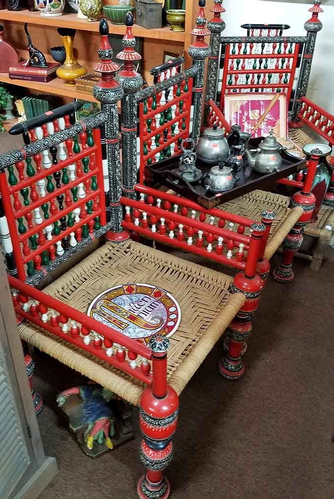 Boldly painted red and black chairs with woven rush seats, the most unexpectedly worldly furniture in all of northwest Alabama.