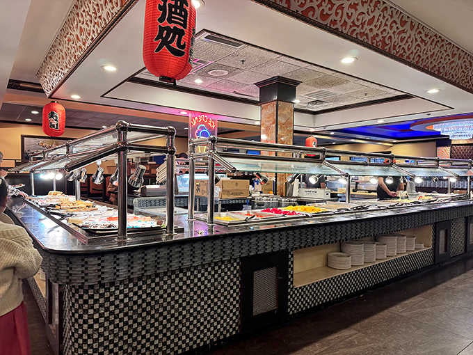 The buffet stations stretch out like a delicious horizon. Red lanterns overhead, fresh food below, happy people everywhere.