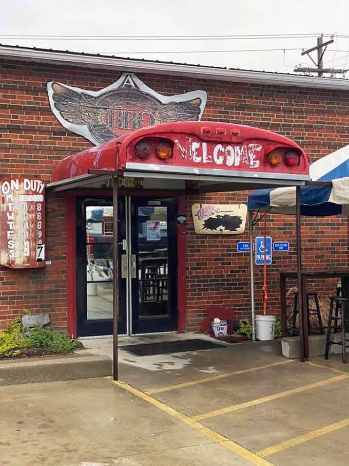 The entrance that promises no pretense, just honest barbecue served with a side of automotive nostalgia.