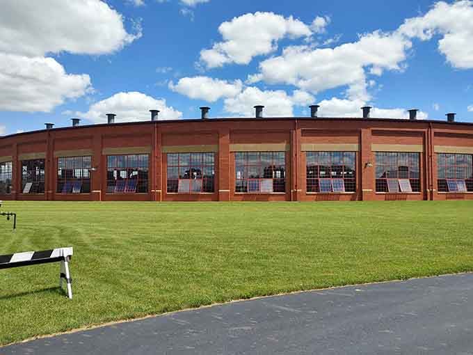 The curved brick facade of the Age of Steam Roundhouse Museum stretches wide under a perfect Ohio sky.