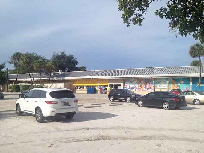 A cheerful mural peeking out from a low-slung building tells you everything. Even the parking lot on Anna Maria Island has personality.