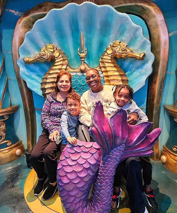 The mermaid throne photo op, where every family suddenly becomes royalty of the deep blue sea, no crown required.