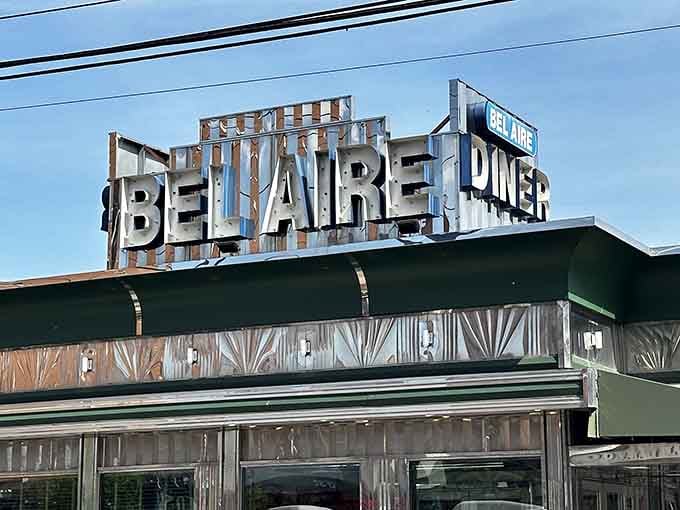 Big letters, bold presence, and a sign that's been earning its spot on that rooftop for a long time.