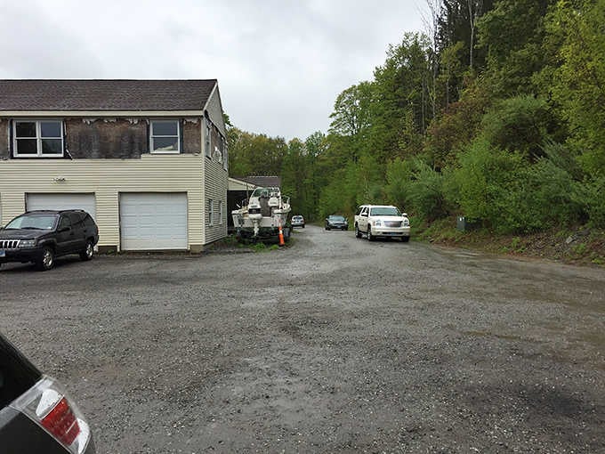 A gravel parking lot surrounded by trees, the quiet beginning of a very unexpected Connecticut adventure.