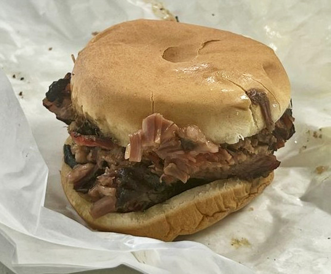 A brisket sandwich so loaded it can barely hold itself together. Honestly, same feeling after finishing one.