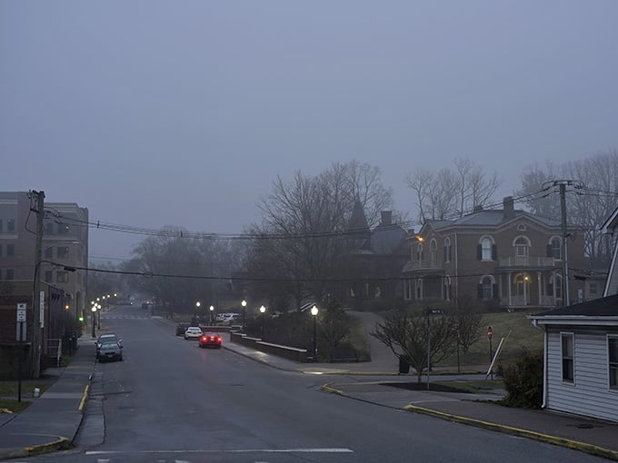 Draper Road at dusk, streetlights cutting through the mist, historic homes glowing softly. Blacksburg does atmosphere effortlessly.