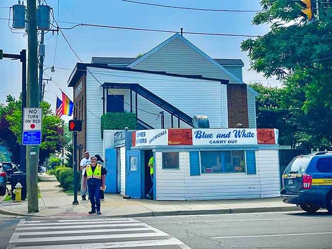 A busy Alexandria corner, people moving in every direction, and Blue and White Carry Out standing steady through all of it. Some things just endure.