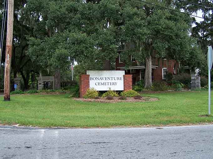 The sign is modest, the trees behind it are not, and that contrast tells you everything you need to know.