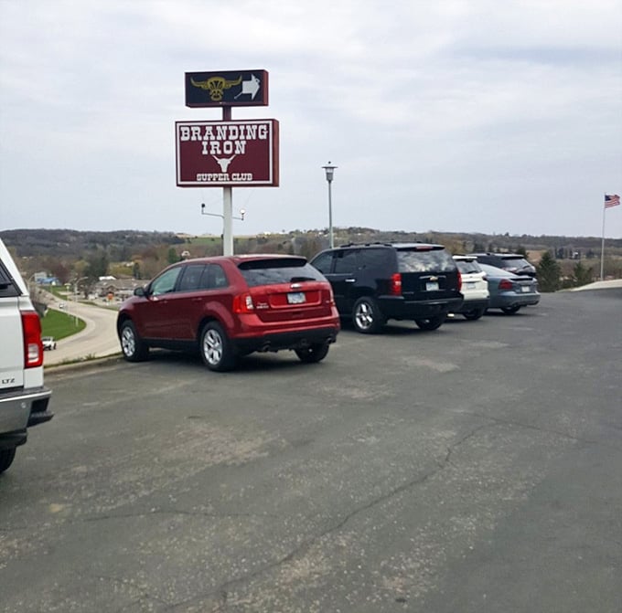 That maroon sign on the hill is your landmark, your beacon, and your very good reason to turn right.