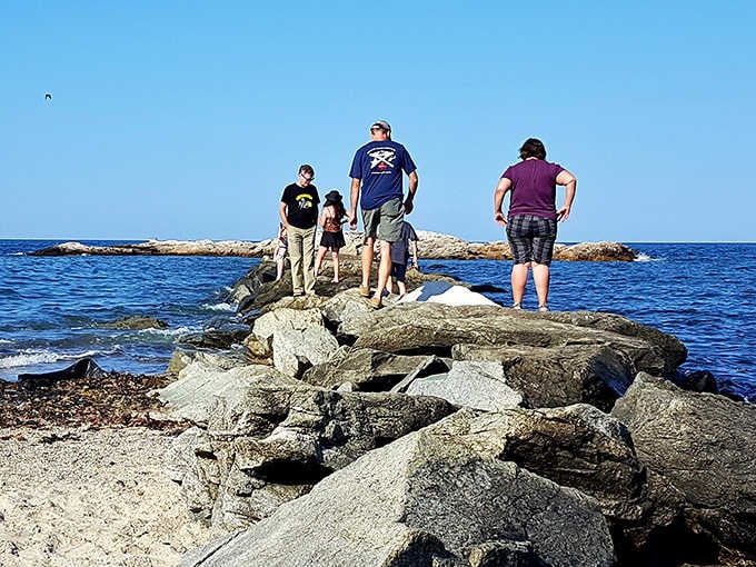 Families climbing the rocks at Brant Rock Beach, making memories that will outlast any souvenir shop purchase.