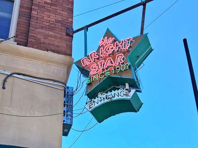 Since 1907 glowing in neon against a blue Alabama sky, some signs don't just mark a location, they mark a legacy.