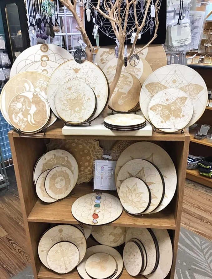Laser-etched wooden crystal grids featuring lotus flowers and butterflies, proof that sacred geometry is genuinely beautiful.