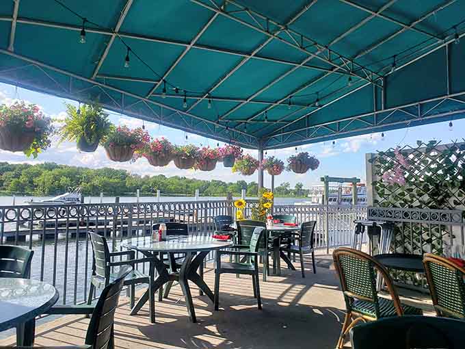 Waterfront dining with hanging flowers and open skies. This patio makes every meal feel like a small celebration.