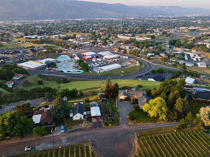 Aerial views reveal a town nestled perfectly between river and hills, affordable living with million-dollar scenery included.