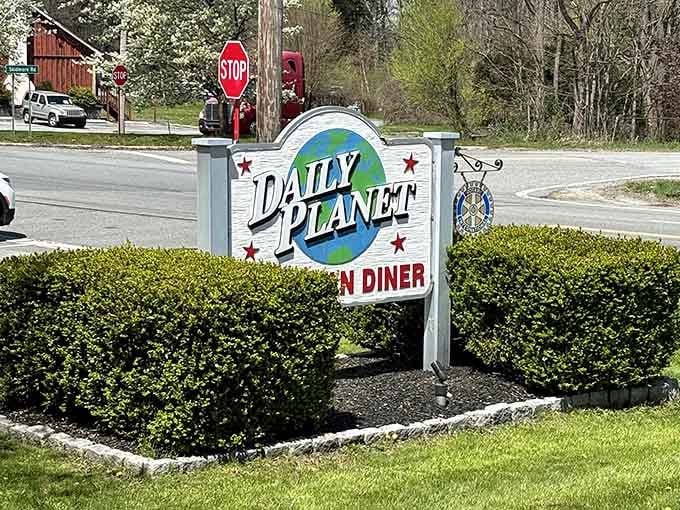 That roadside sign with the globe and the stars is your landmark. When you see it, turn in.