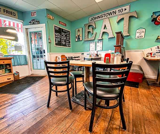 Big letters spelling EAT on the wall, a Johnstown road sign, and biscuits and gravy on the menu. Perfect.
