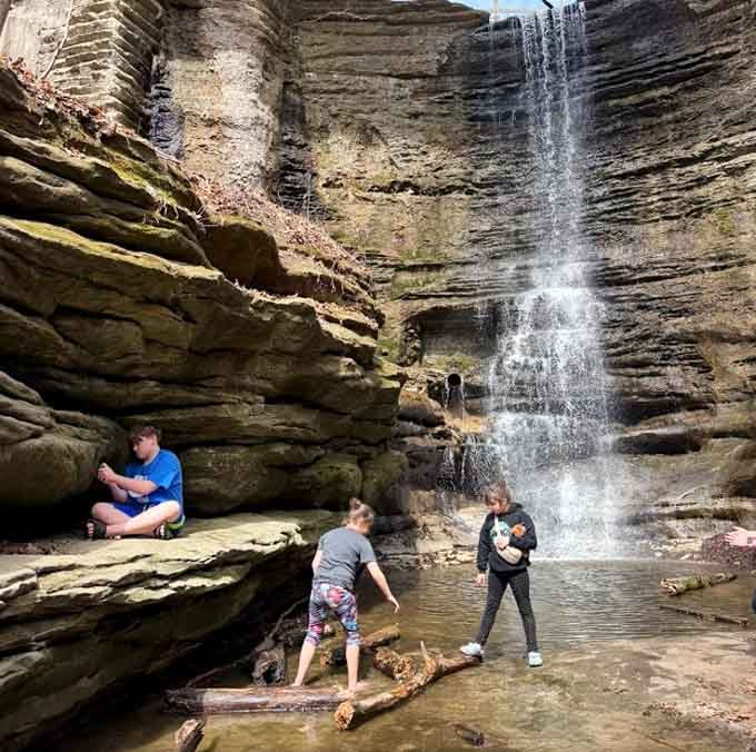 Kids playing at the base of the waterfall, completely unbothered by anything. That's the right idea, honestly.