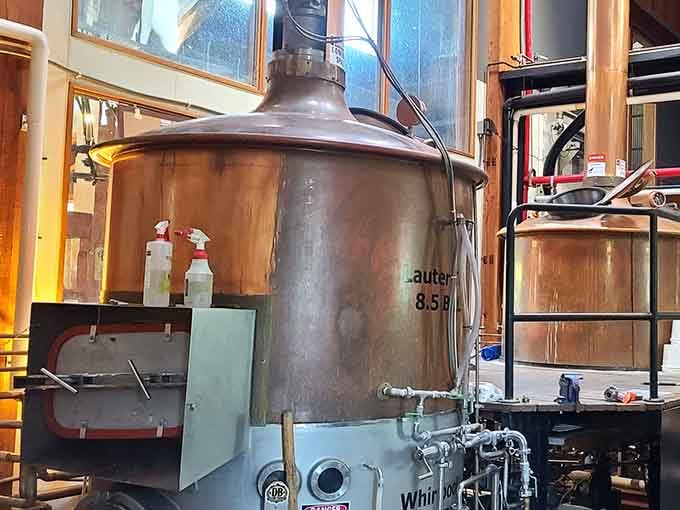 Gleaming copper brewing tanks doing the important work. Behind every great pint is a room that looks exactly this serious and this beautiful.