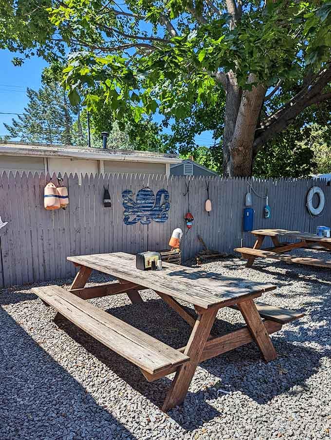 Picnic tables, gravel underfoot, and lobster buoys on the fence. Outdoor dining doesn't get more authentically coastal than this.
