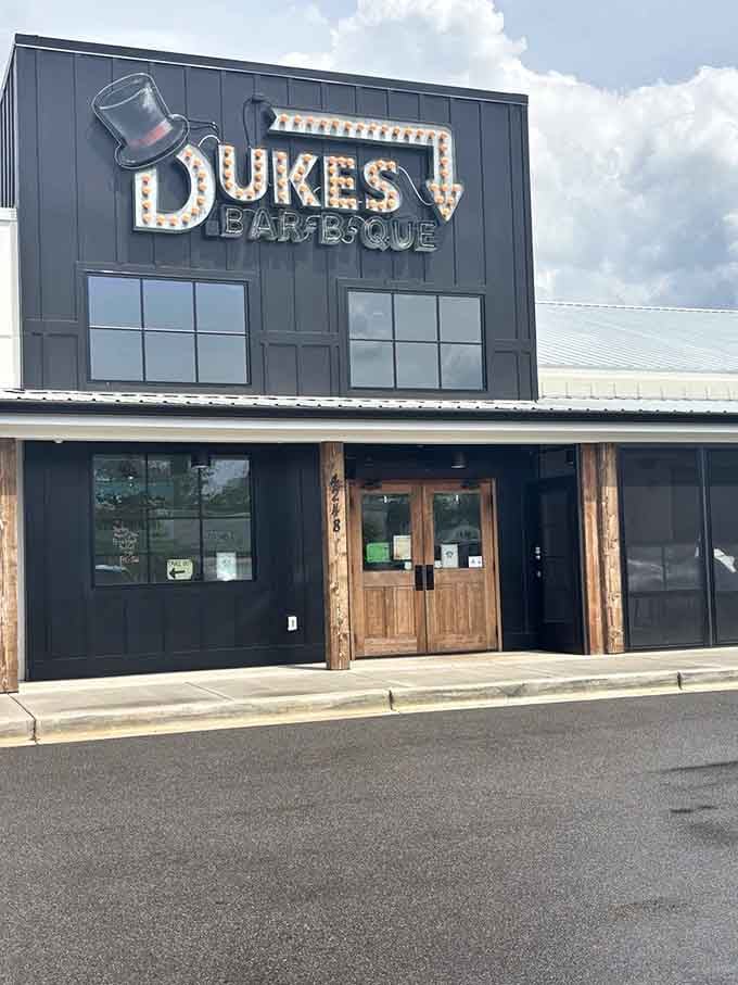 Those marquee lights spelling out Dukes Bar-B-Que aren't just a sign, they're a promise the kitchen keeps every day.