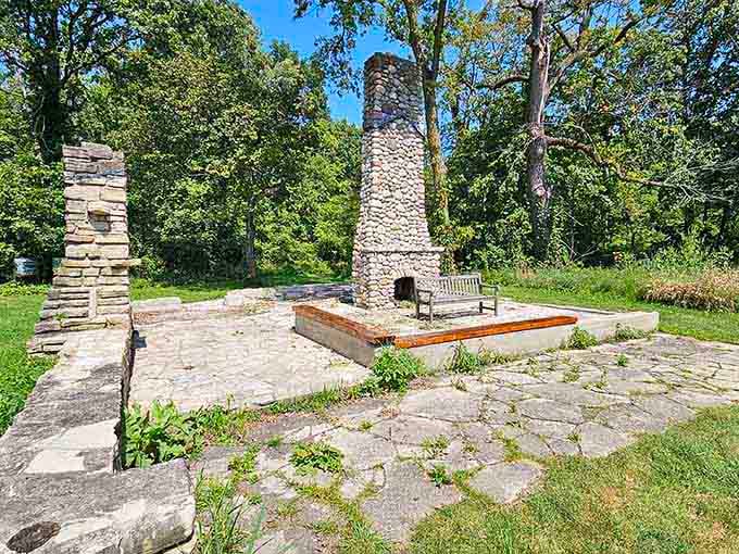 Stone chimney remnants stand as quiet reminders that people once called these woods home, long before smartphones existed.