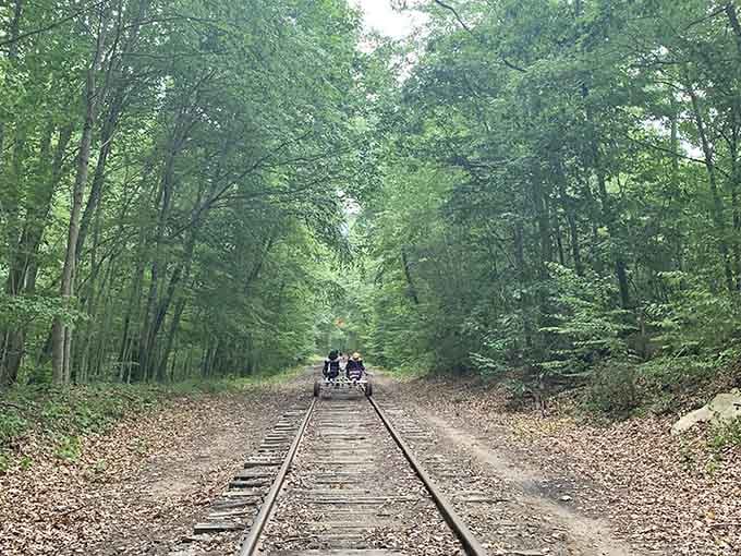 Two riders disappear into a tunnel of green, heading somewhere quiet and wonderful. You should follow them.