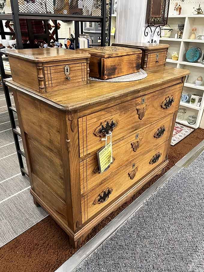Victorian walnut dresser with gorgeous hardware, the kind of furniture that makes IKEA instructions weep with inadequacy.