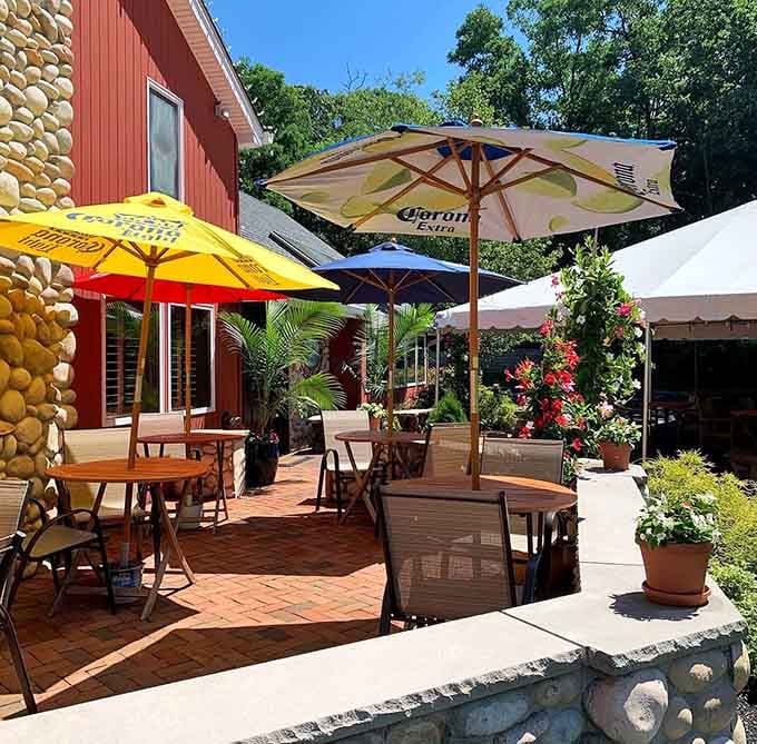 A sunny brick patio with colorful umbrellas and blooming flowers, outdoor dining that makes a Jersey summer feel perfect.