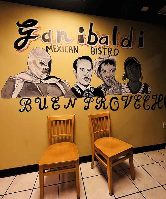 Buen Provecho painted beneath a luchador and Mexican cultural icons, this mural is basically the restaurant's entire personality in one wall.