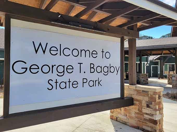 That bold welcome sign framed by timber and stone sets the tone perfectly. George T. Bagby State Park means serious business.