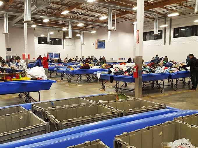 The full picture of the Goodwill Outlet floor, rows of blue bins stretching out like a thrifter's version of paradise.