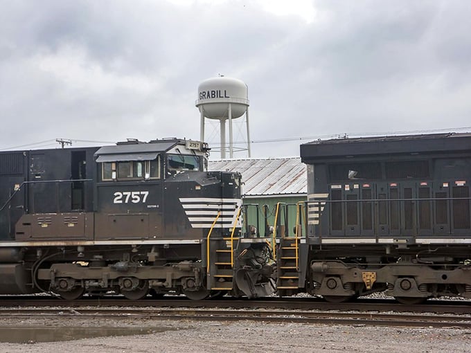 The Grabill water tower stands tall above a passing train, quietly announcing, "You've arrived somewhere worth stopping."