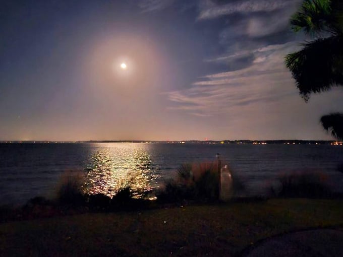 A full moon over the water, seen from a historic lighthouse on a car-free island. Sleep is entirely optional tonight.