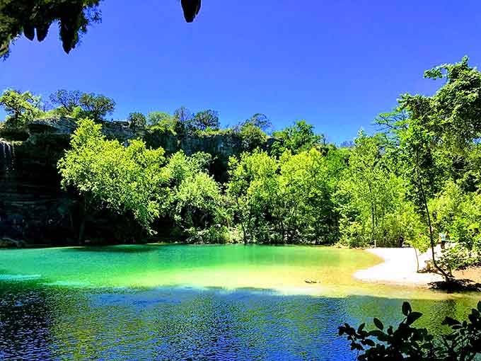 The beach area where jade water meets limestone shore, proving Texas has surprises beyond barbecue.