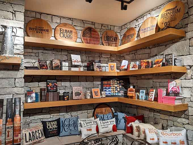 Barrel heads, branded pillows, and bourbon books stacked on stone shelves. The gift shop that keeps on giving.