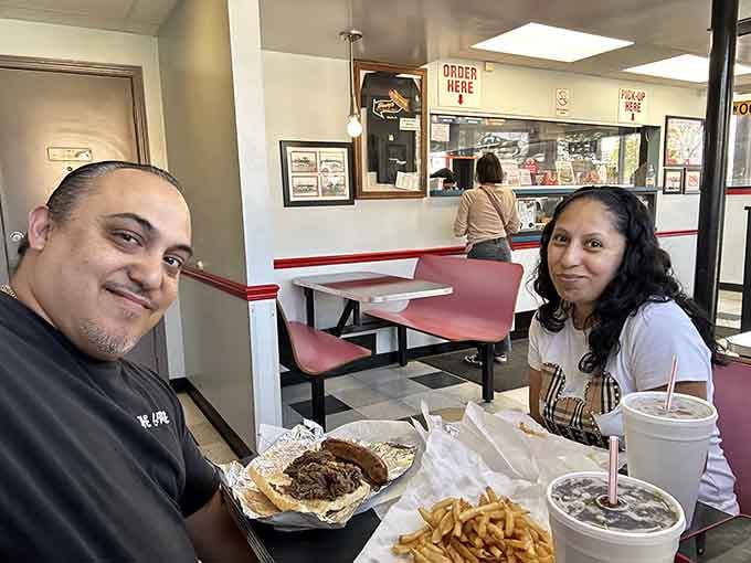 Two happy diners, a spread of Henry's finest, and smiles that say everything the menu already told you, this place delivers joy.
