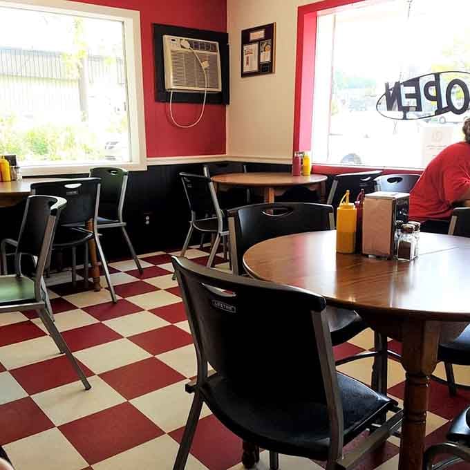 Bright windows, round wooden tables, and mustard bottles ready for action. Hinkle's dining room is always open for business.