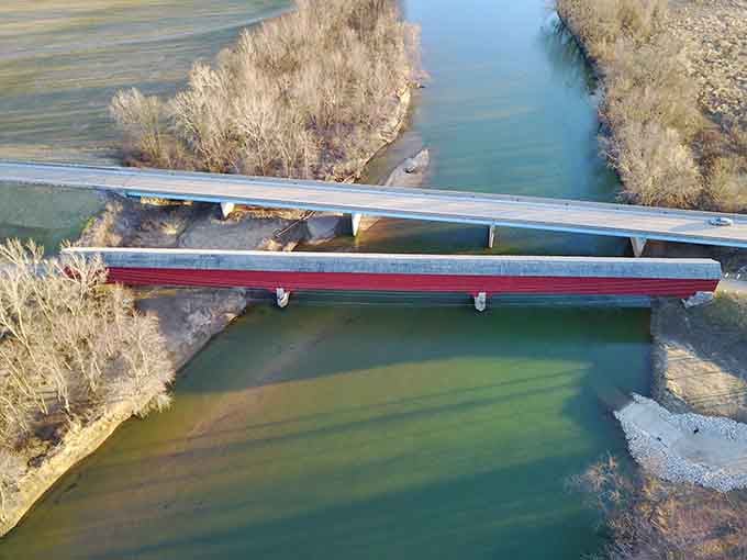 From above, the old covered bridge and its modern neighbor side by side tell the whole story of time passing.
