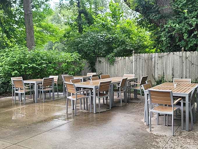 An outdoor patio tucked beneath a canopy of trees, because sometimes the best seat in the house is outside.