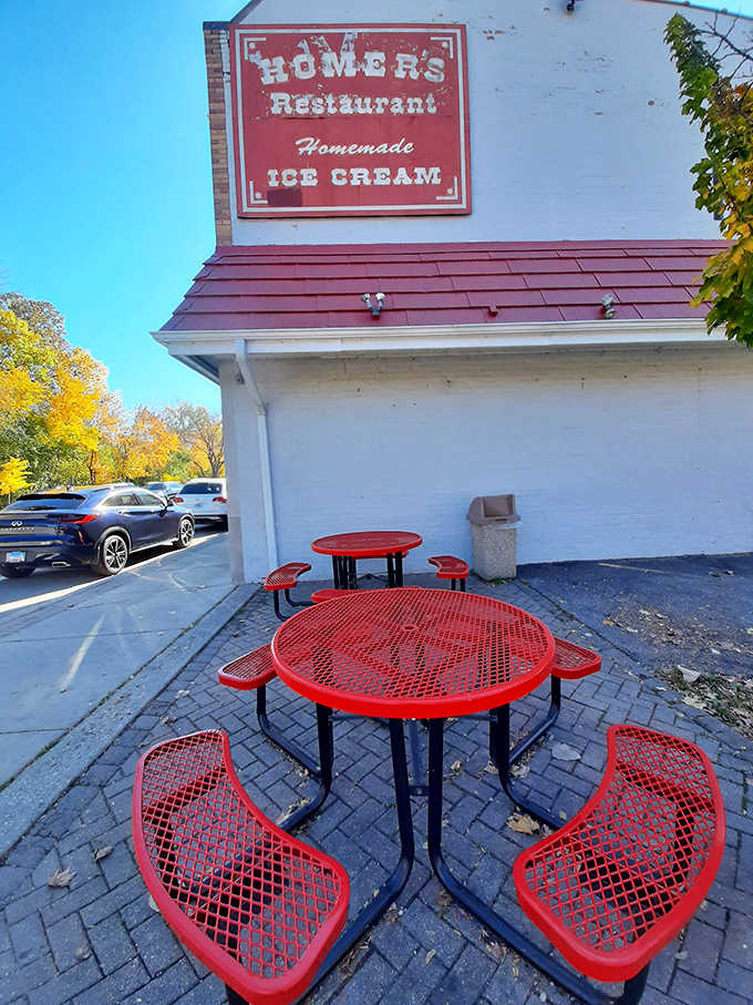 Red tables outside, blue sky above, and homemade ice cream in hand. Homer's outdoor seating is simple perfection.