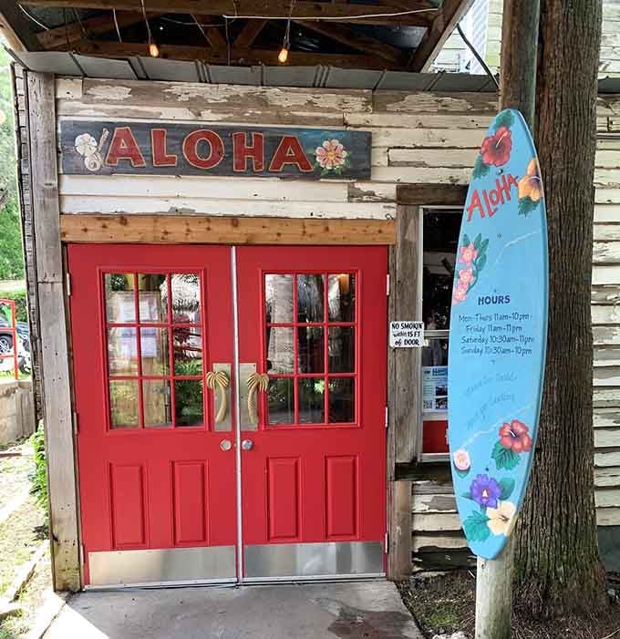 That bright red door with an "Aloha" sign above it is basically the universe telling you to walk right in.