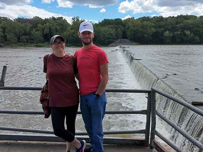 Standing in front of the dam, looking like two people who just discovered something worth coming back for.