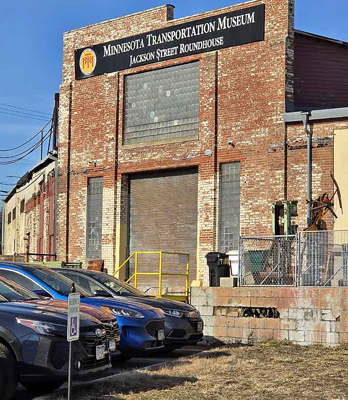 The Minnesota Transportation Museum sign on that weathered brick wall is understated, just like the treasure hiding behind it.